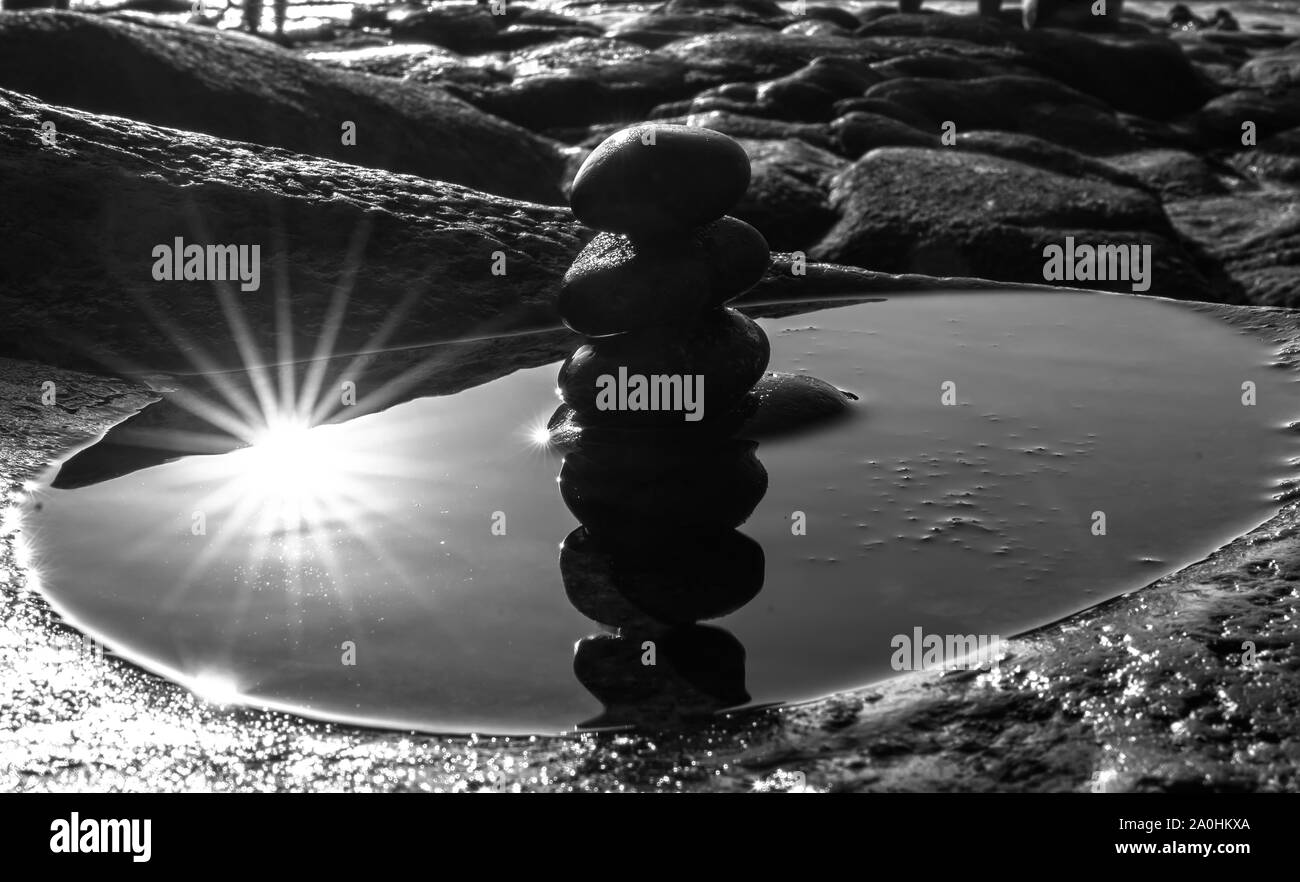 Stacked Pebbles art on mossy rocks welcomes beautiful new day Stock ...