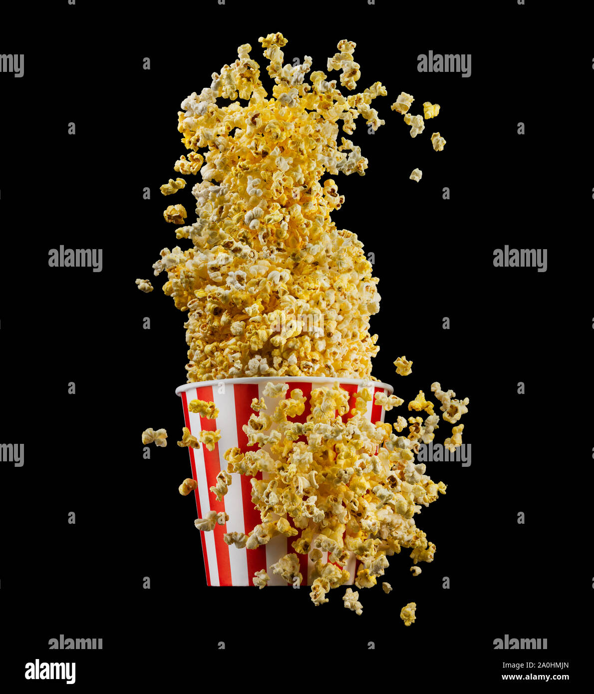 Flying popcorn from striped bucket isolated on black background Stock ...