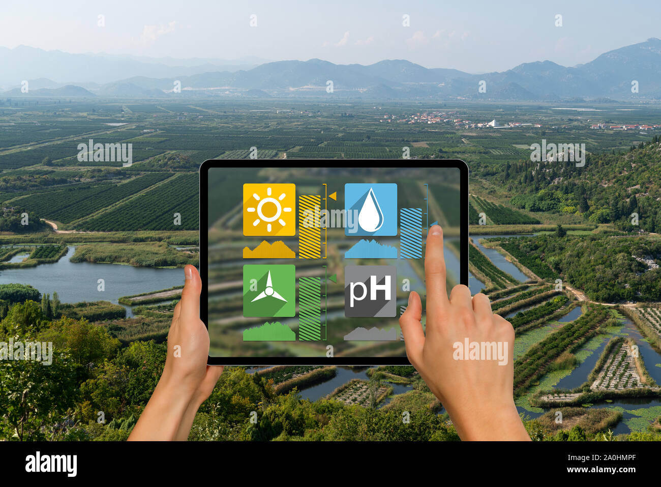 A farmer is holding a tablet. Smart farming and digital agriculture ...