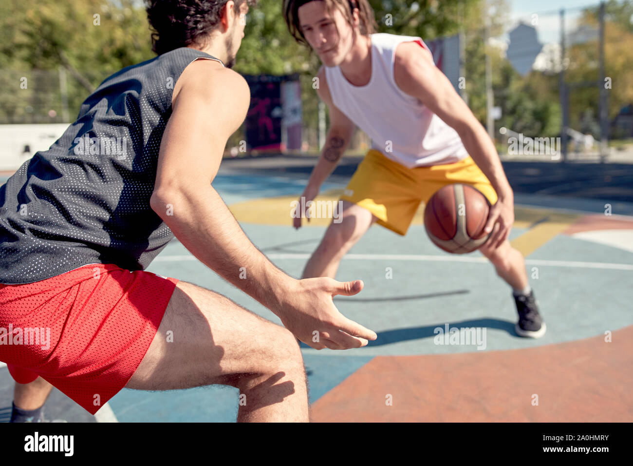 Image of young sports men playing basketball on playground on summer ...