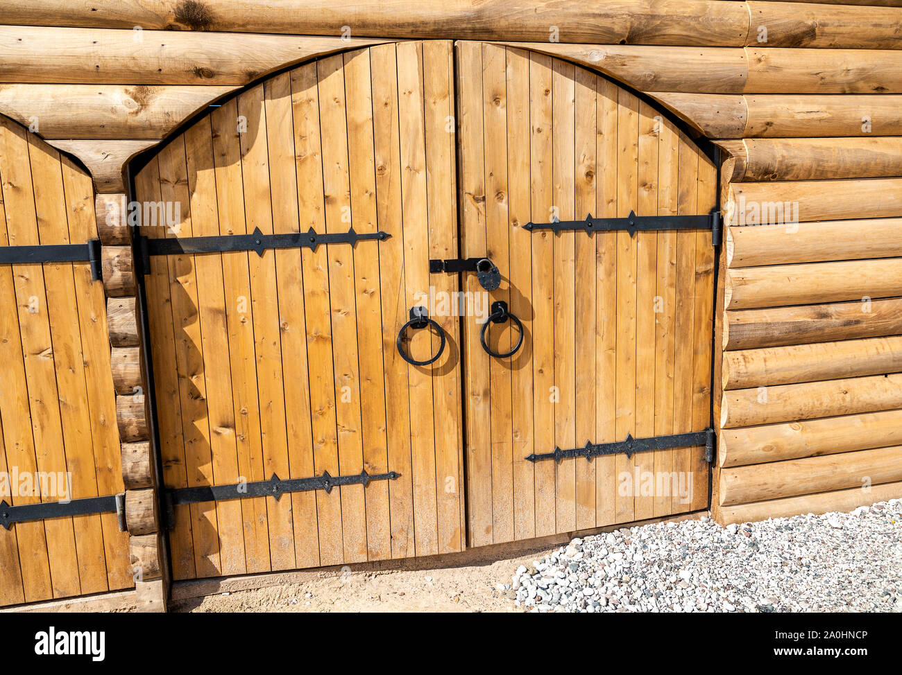 Traditional russian massive wooden gate with forged metal hinges and ...
