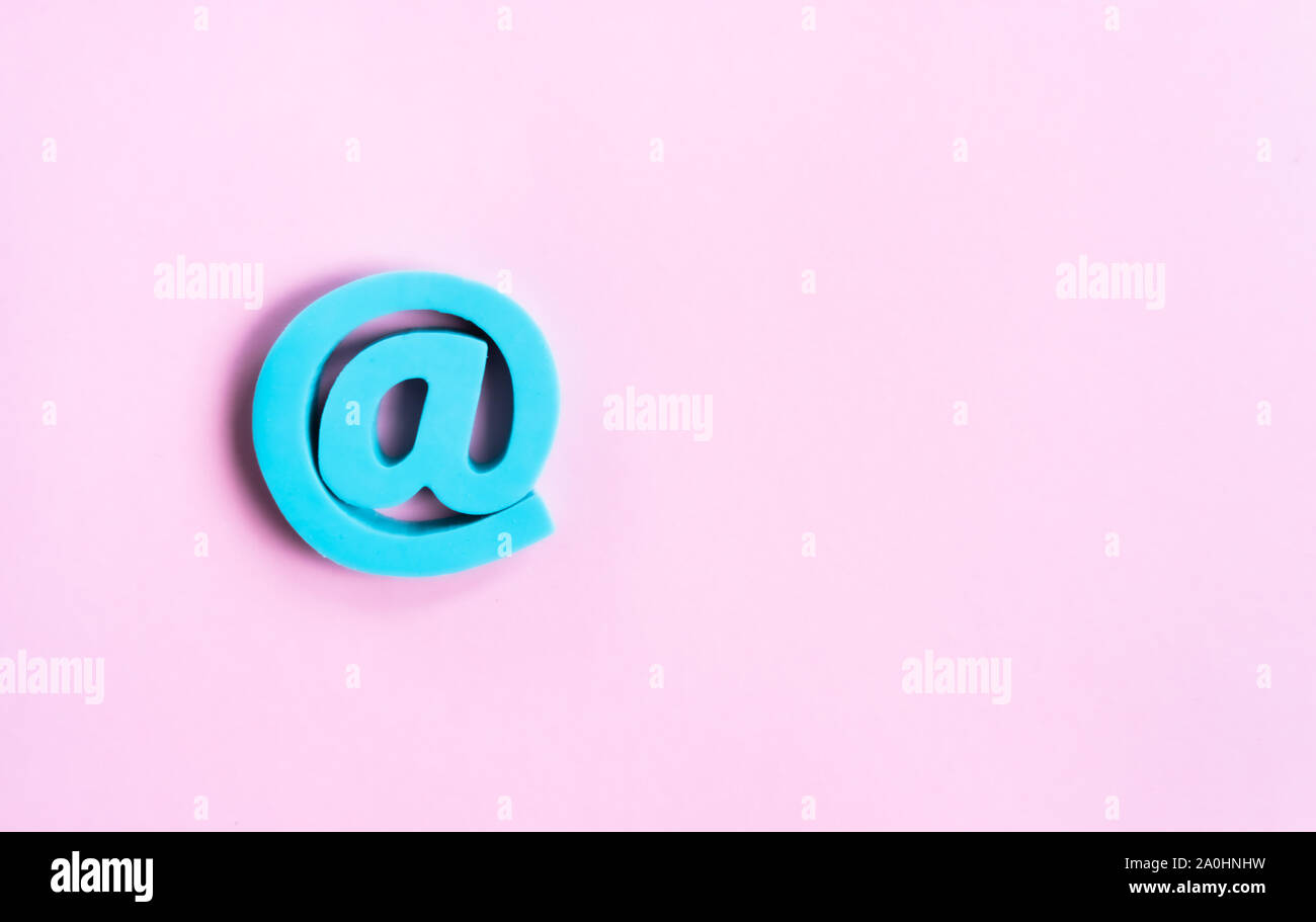 Trendy mint blue at sign on pastel pink background. Email symbol ...