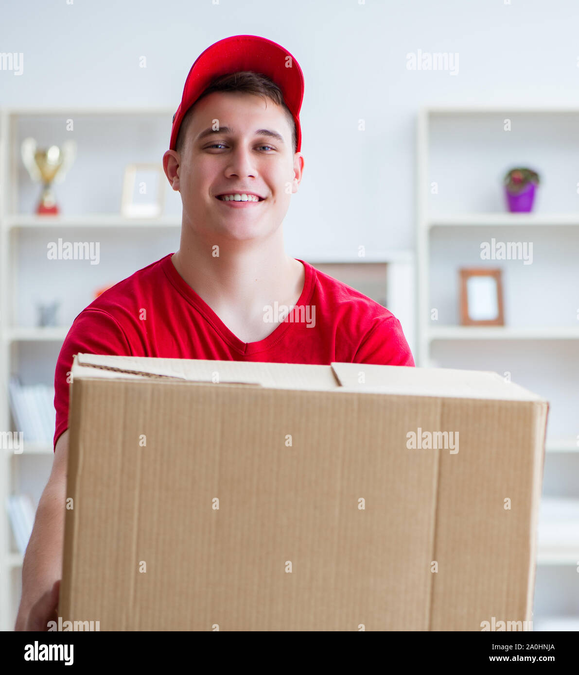 The post man delivering a parcel package Stock Photo - Alamy