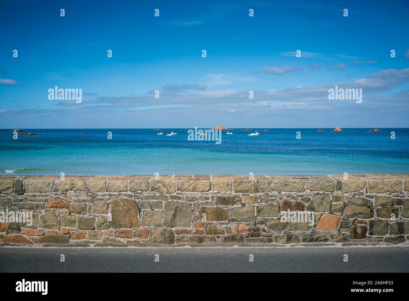Beautiful sun drenched Cobo Bay on the west coast of the island of ...