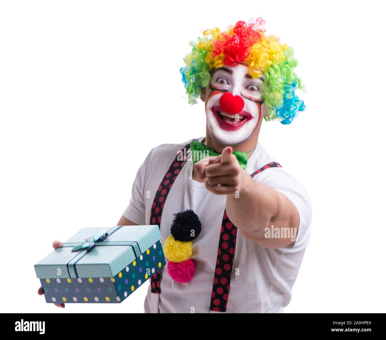 The funny clown with a gift present box isolated on white background ...