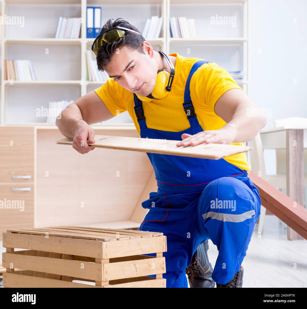 The repairman carpenter inspecting examining a wooden board plank Stock ...