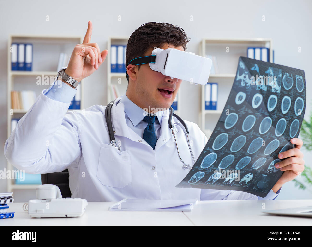 The young doctor looking at mri scan through vr glasses Stock Photo - Alamy