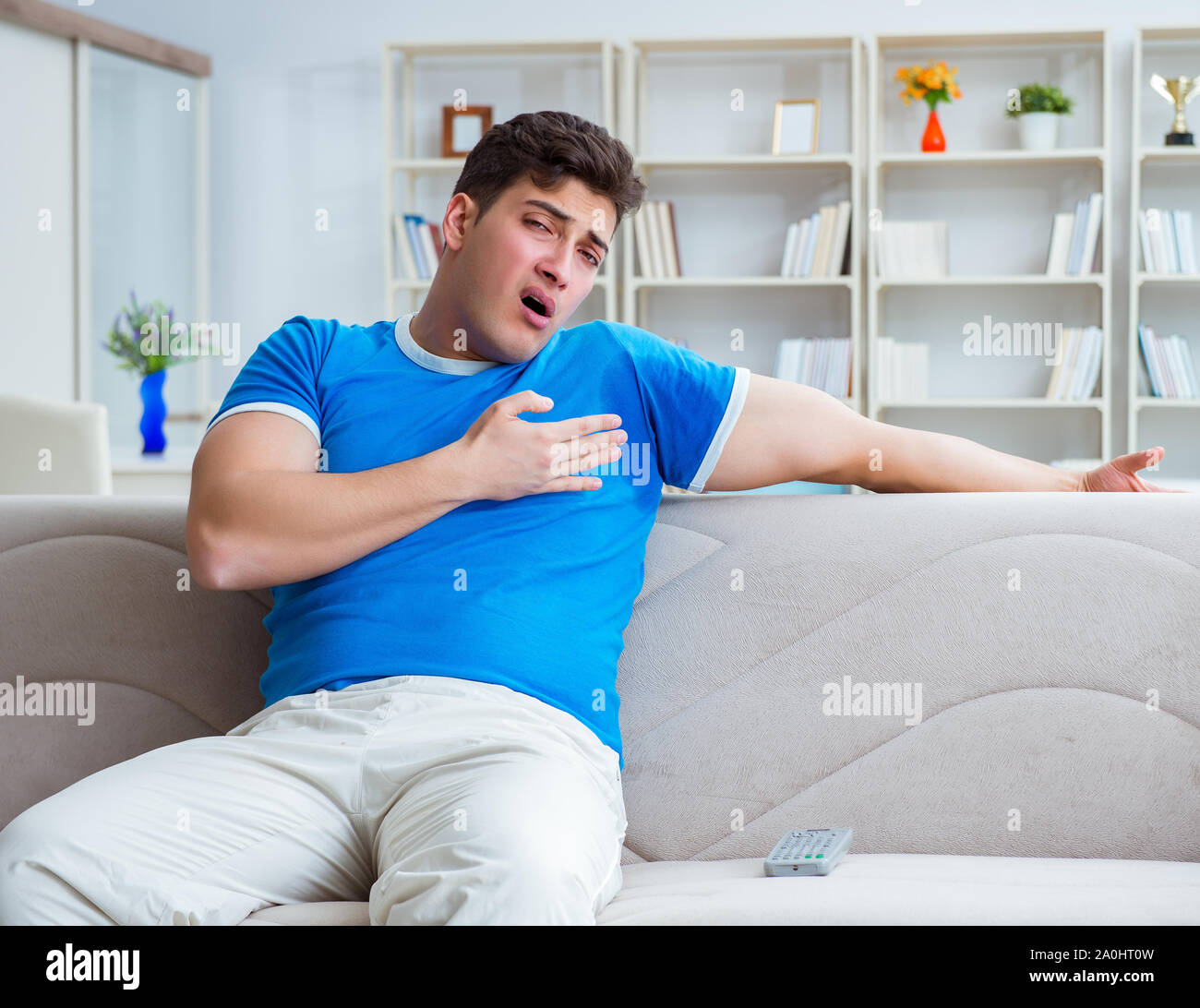 The man sweating excessively smelling bad at home Stock Photo - Alamy