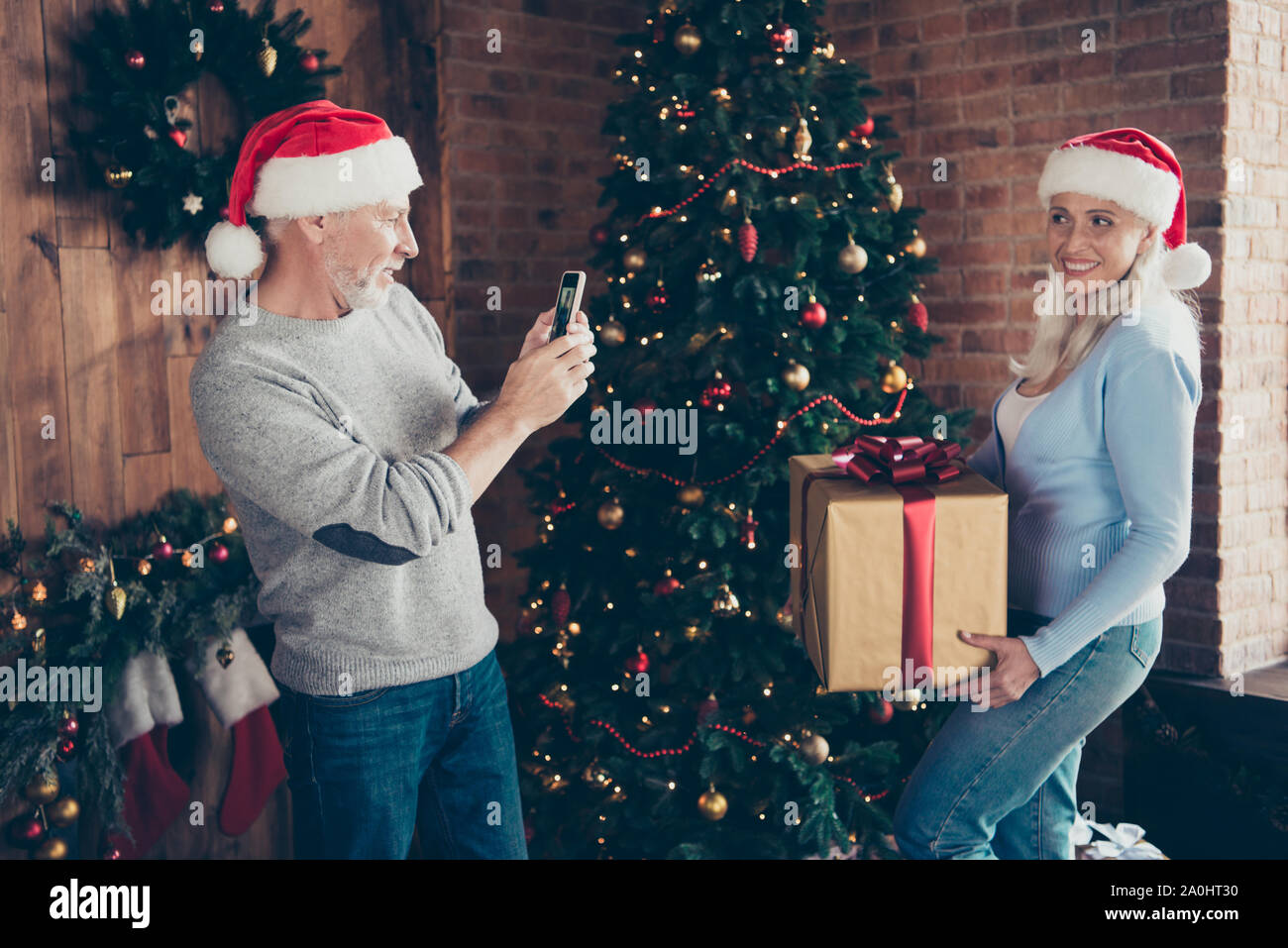 Two grey-haired people husband taking making photo on smart gadg Stock ...