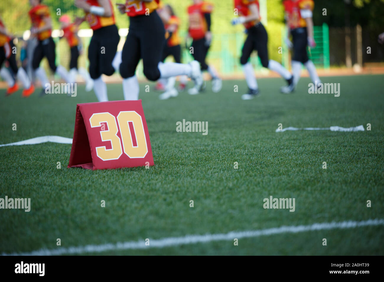 Photo of soccer field with number thirty running football players on ...