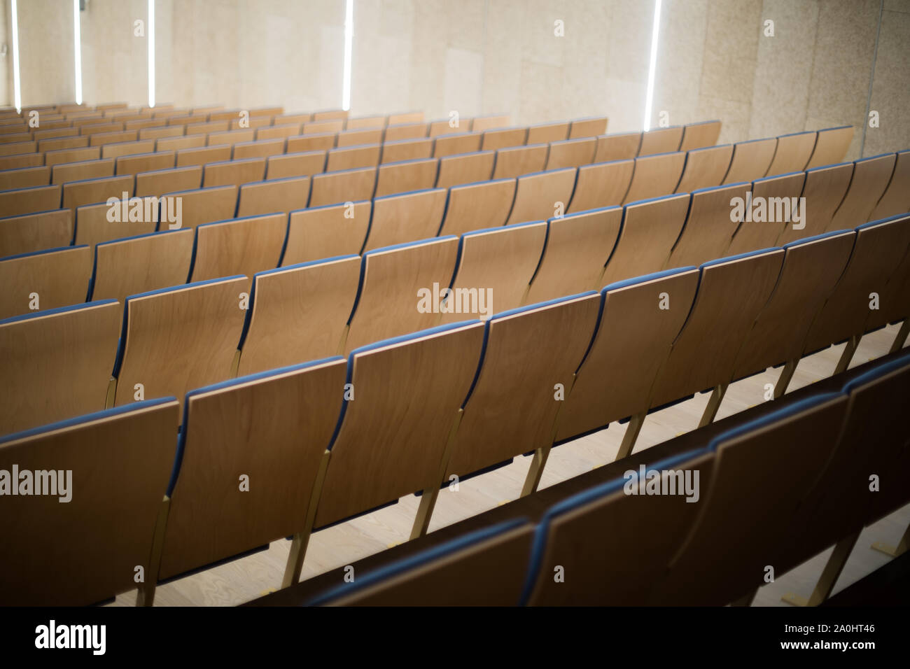 Image of rows of empty wooden seats in a conference room Stock Photo ...