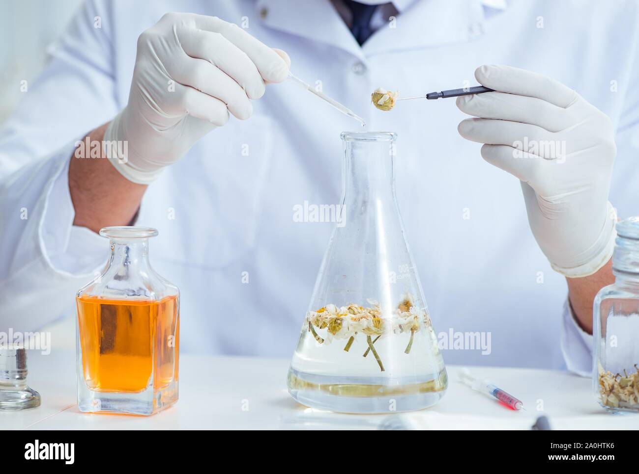 The chemist mixing perfumes in the lab Stock Photo - Alamy