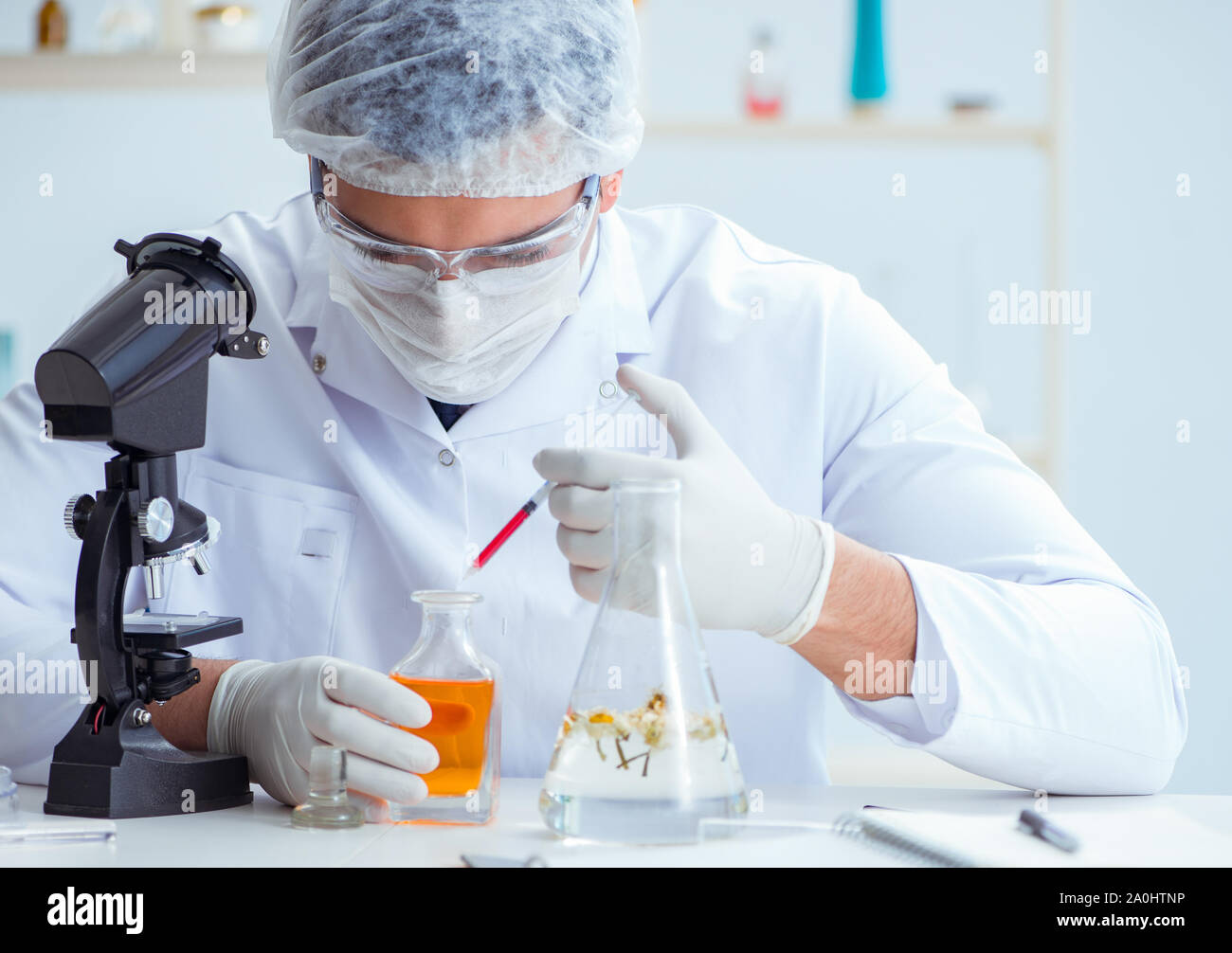 The chemist mixing perfumes in the lab Stock Photo - Alamy