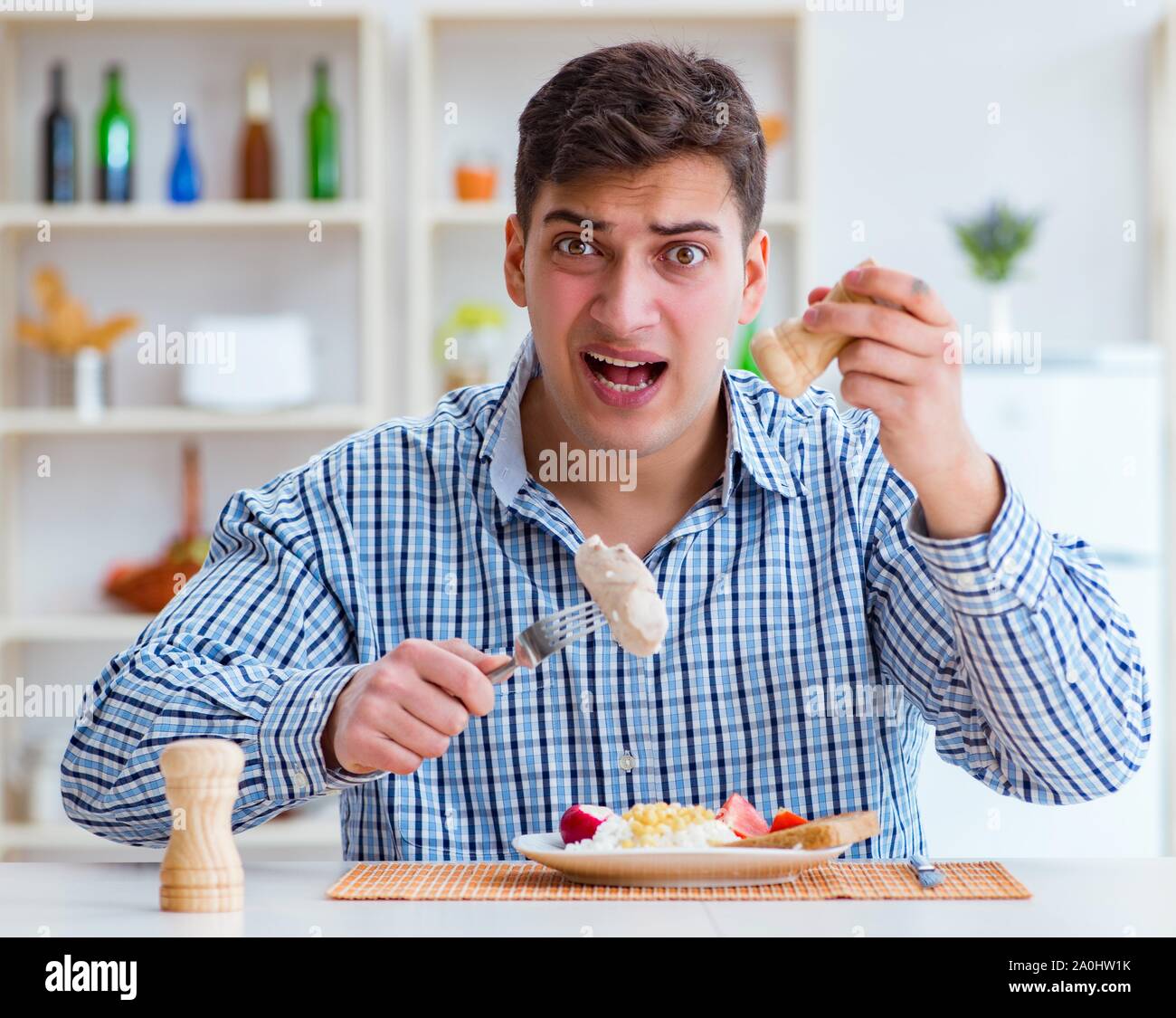 The man eating tasteless food at home for lunch Stock Photo - Alamy
