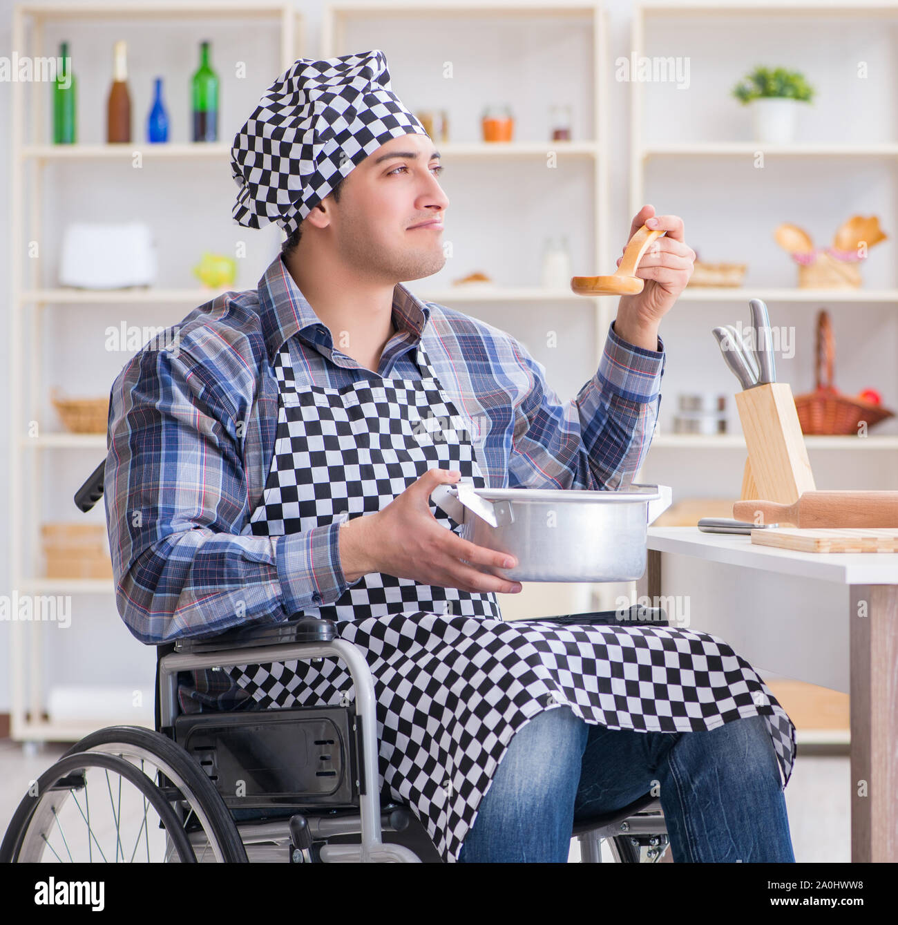 The disabled man preparing soup at kitchen Stock Photo - Alamy