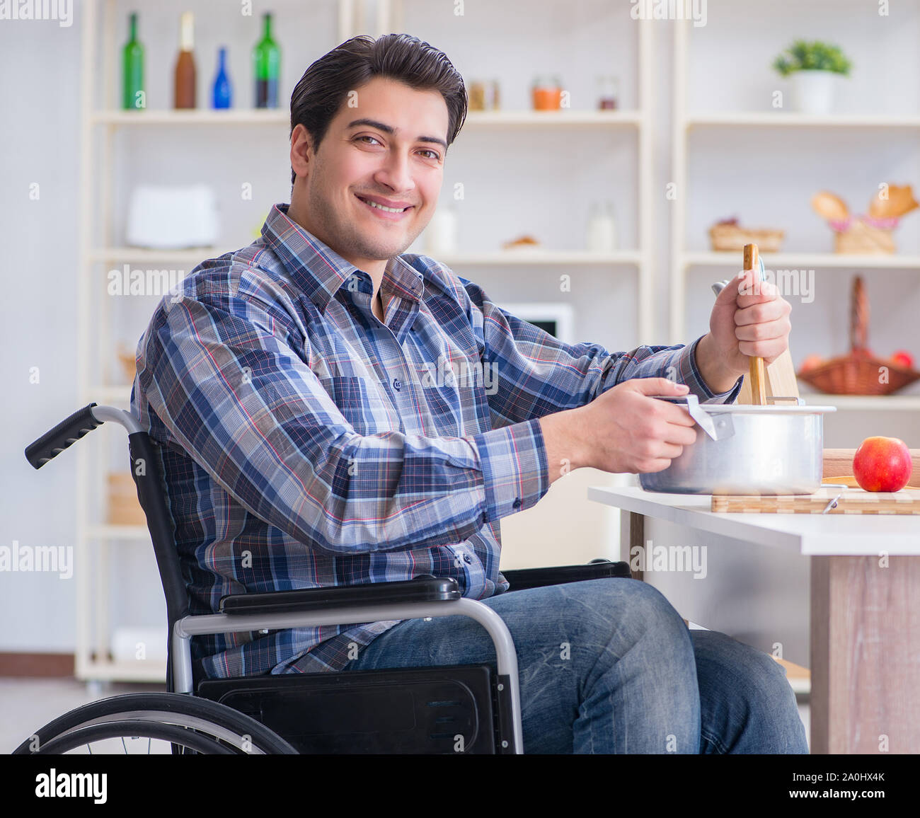 The disabled man preparing soup at kitchen Stock Photo - Alamy