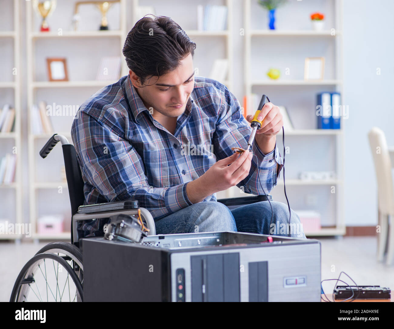 The computer repairman on wheelchair working Stock Photo - Alamy