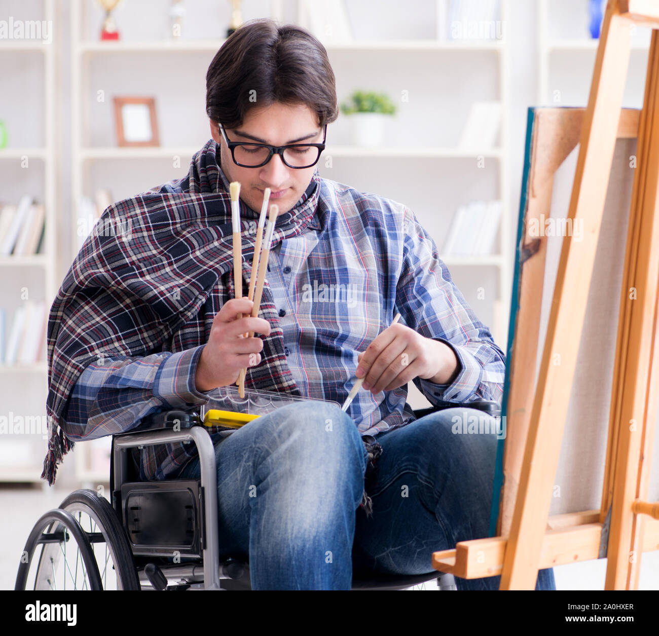 The disabled artist painting picture in studio Stock Photo - Alamy