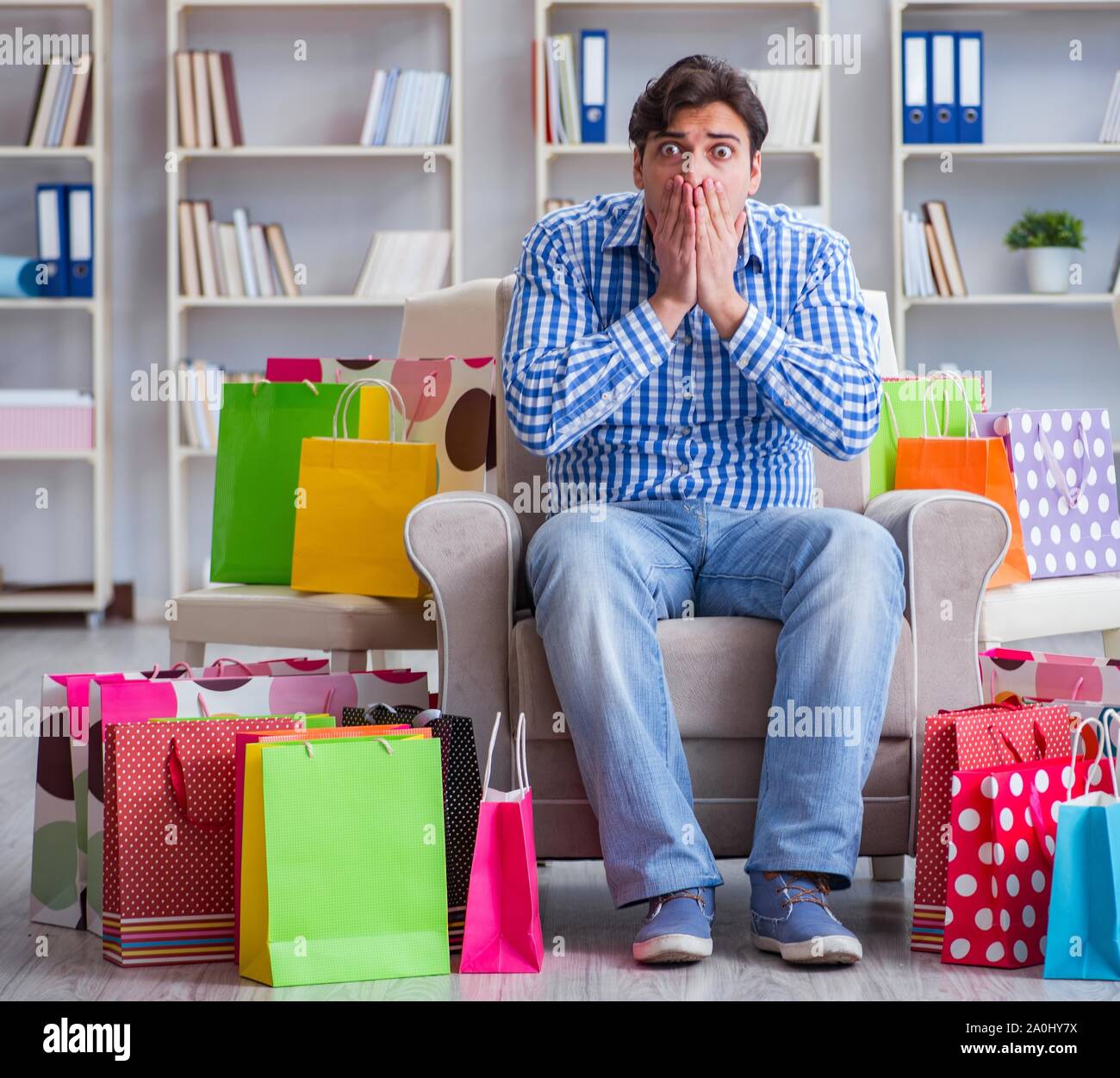 The young man after excessive shopping at home Stock Photo - Alamy