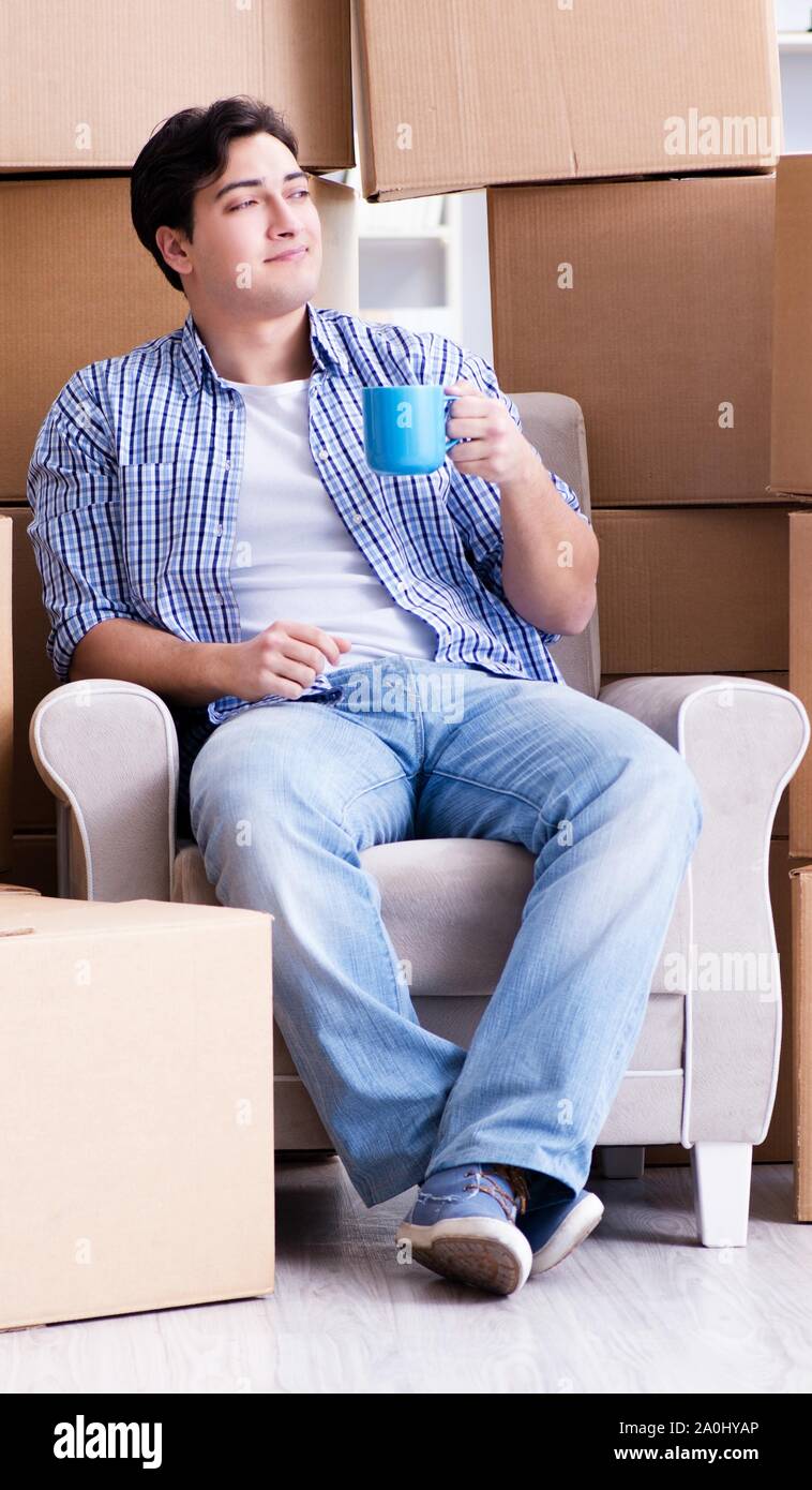 The young man moving in to new house with boxes Stock Photo - Alamy