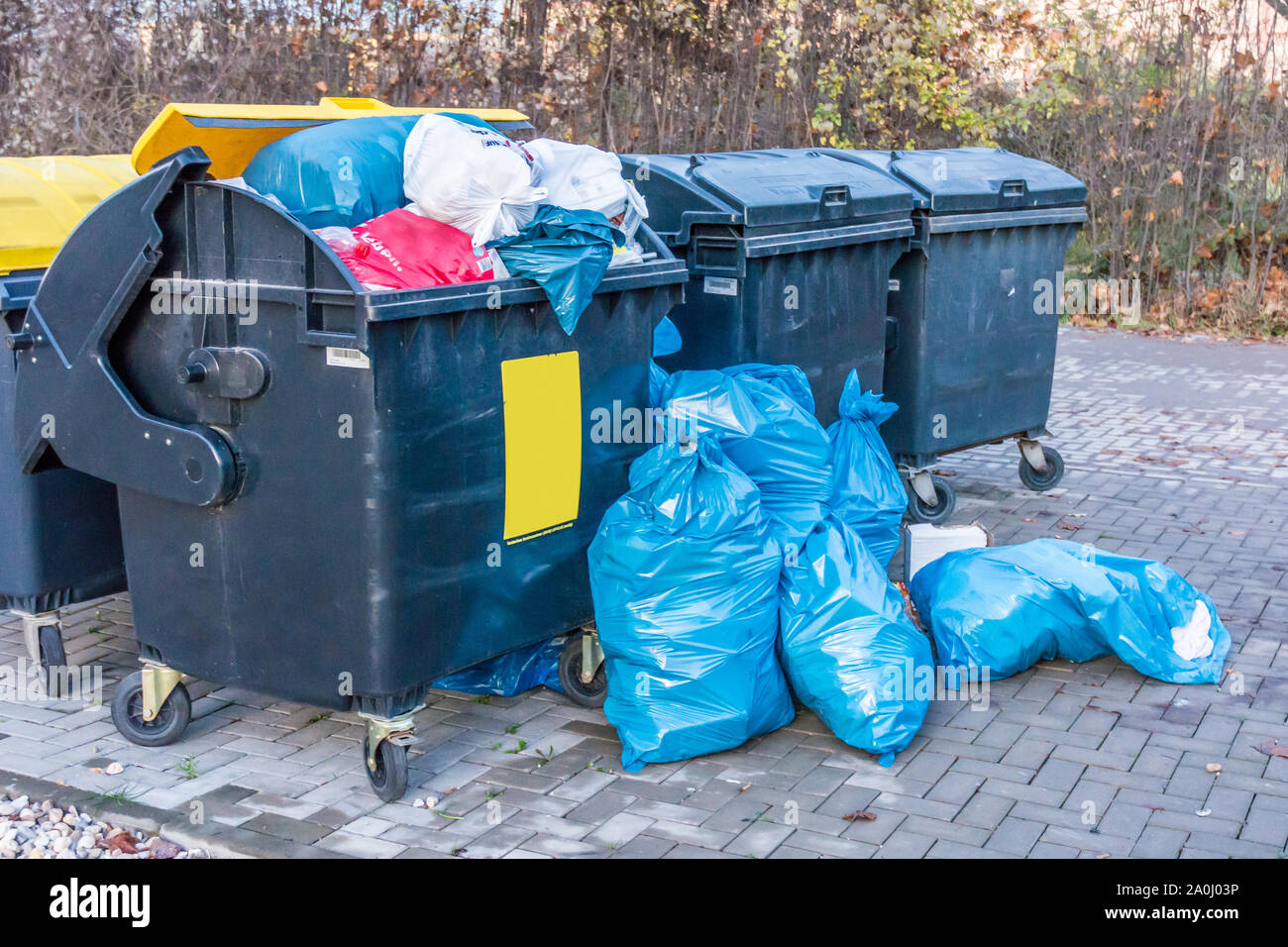 Garbage piles at the garbage cans Stock Photo - Alamy