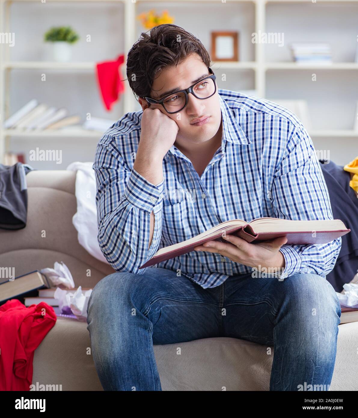 The young man working studying in messy room Stock Photo - Alamy