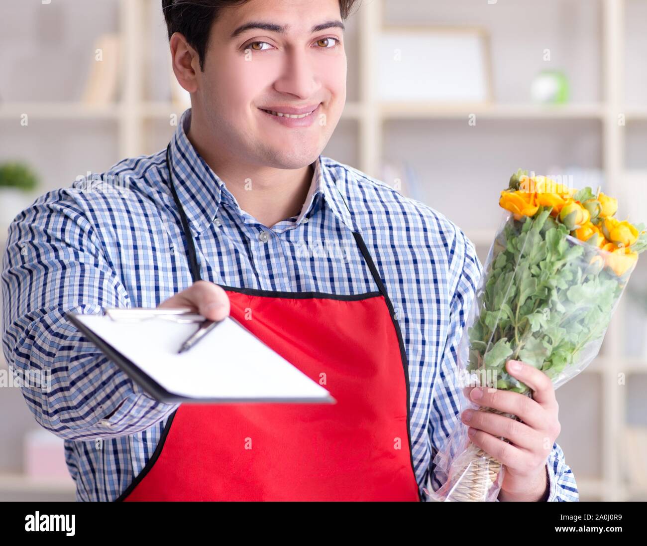 The flower shop assistant offering a bunch of flowers Stock Photo - Alamy