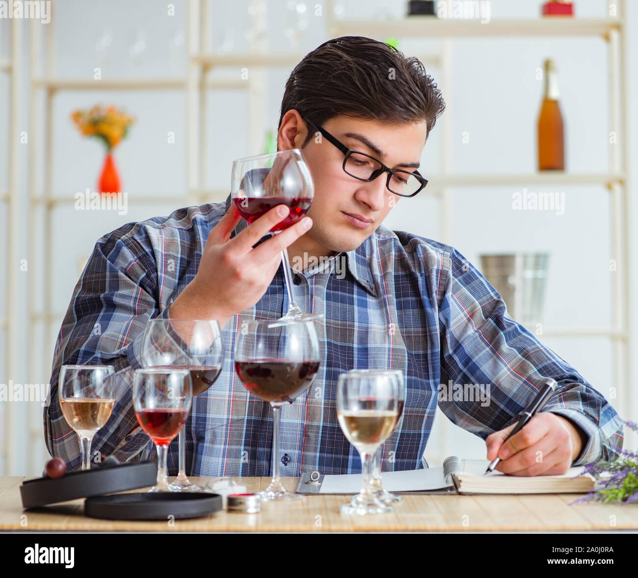 The professional sommelier tasting red wine Stock Photo - Alamy