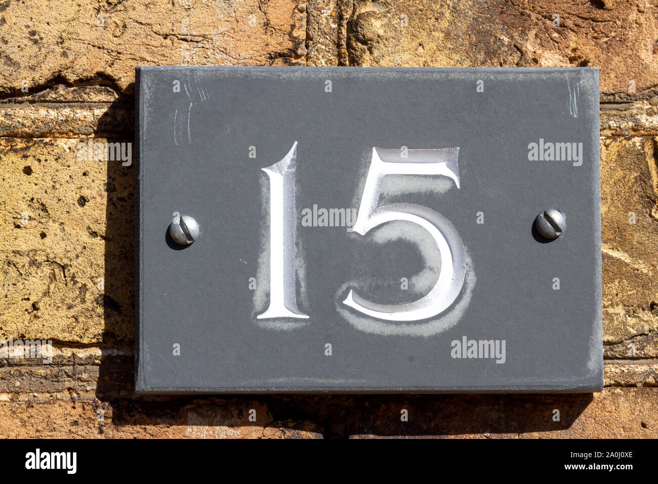 House number 15 on black slate on a brick wall Stock Photo - Alamy