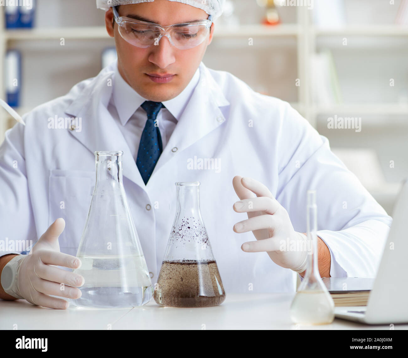 Young researcher scientist doing a water test contamination experiment ...