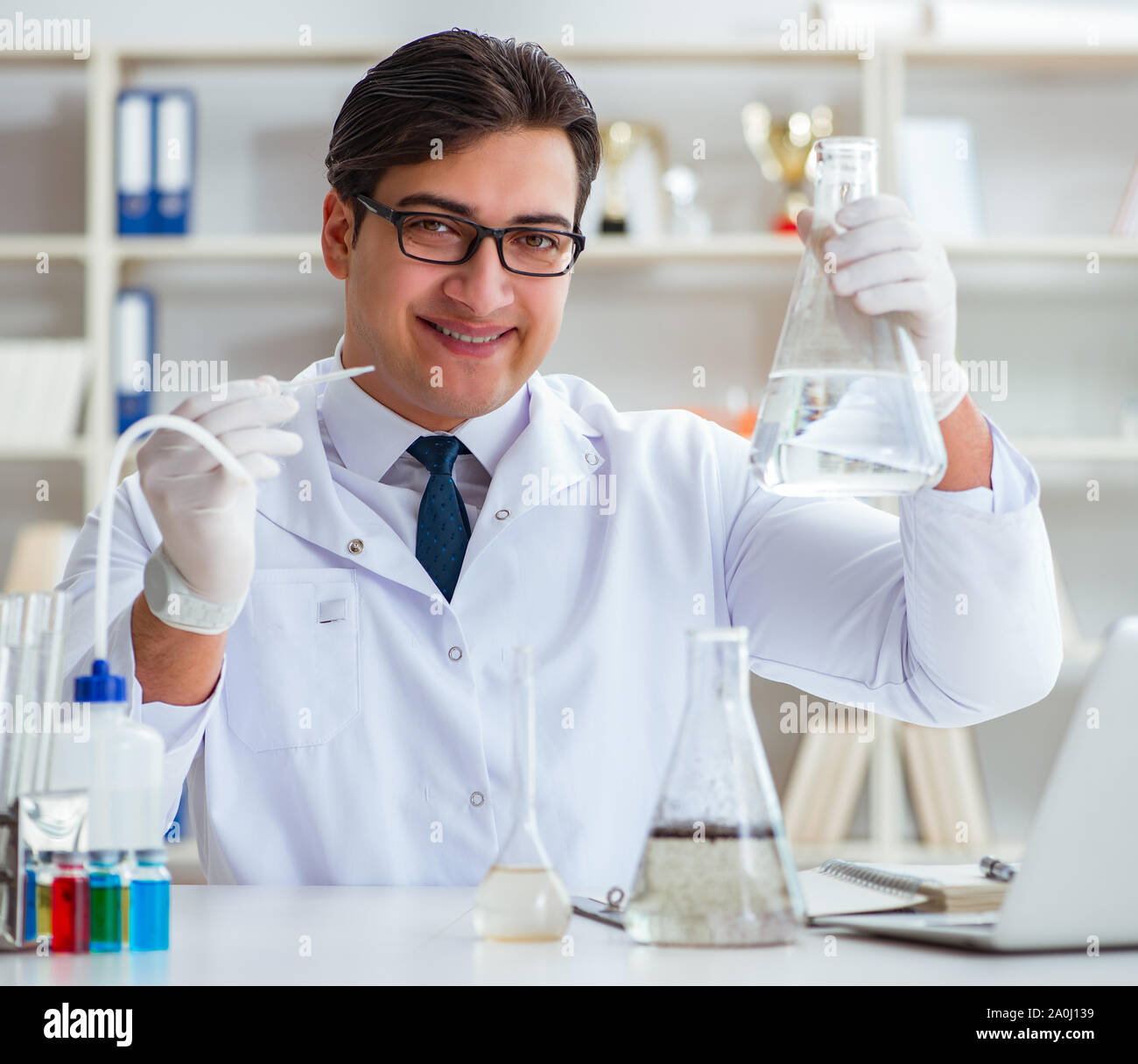 Young researcher scientist doing a water test contamination experiment ...