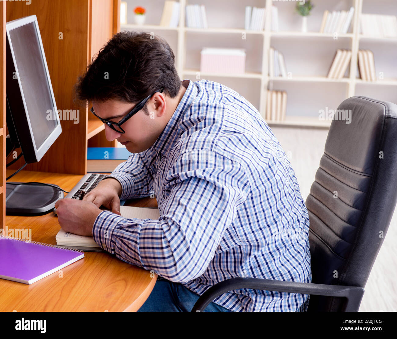 The young student at computer table Stock Photo - Alamy