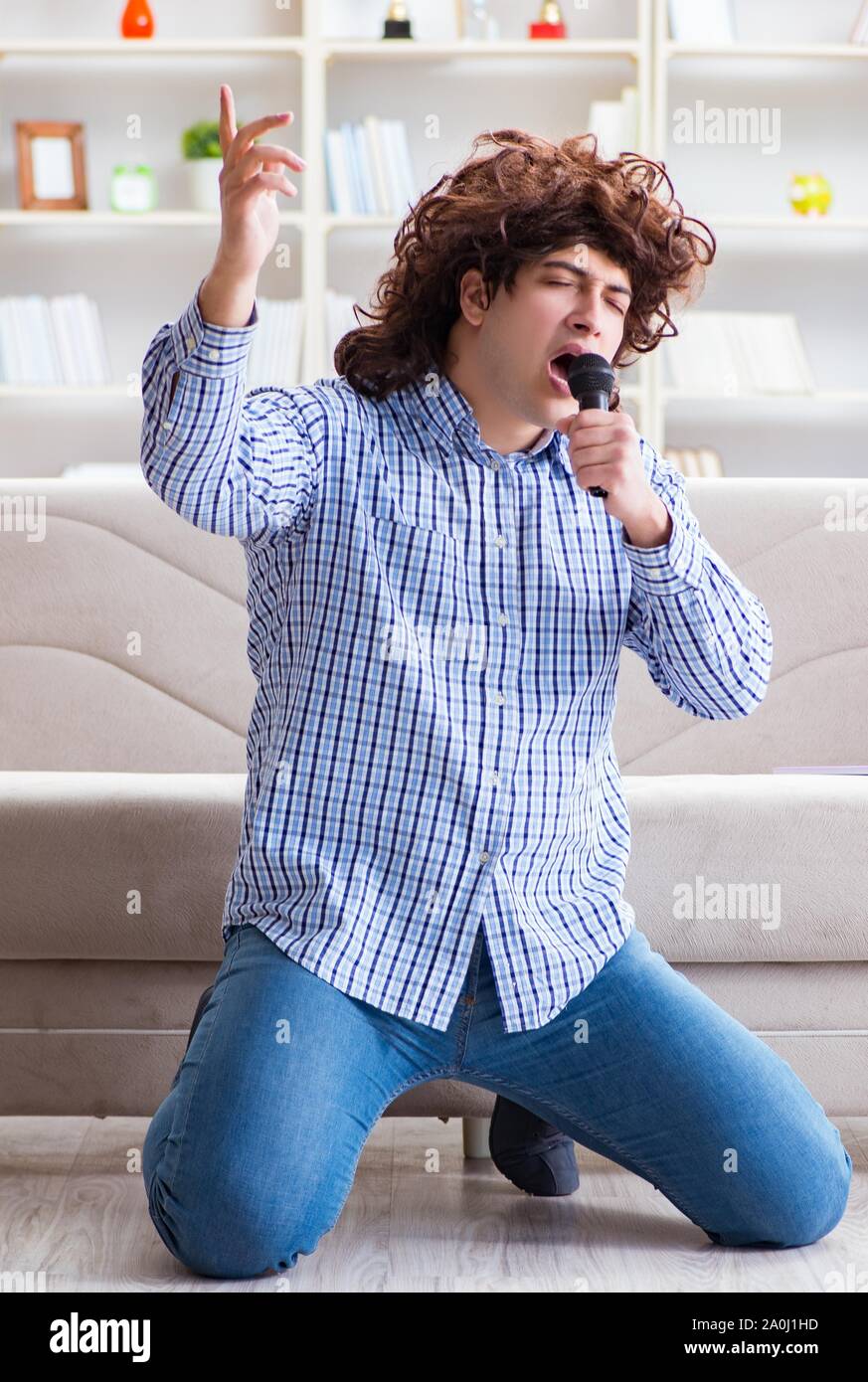The funny man singing songs in karaoke at home Stock Photo - Alamy