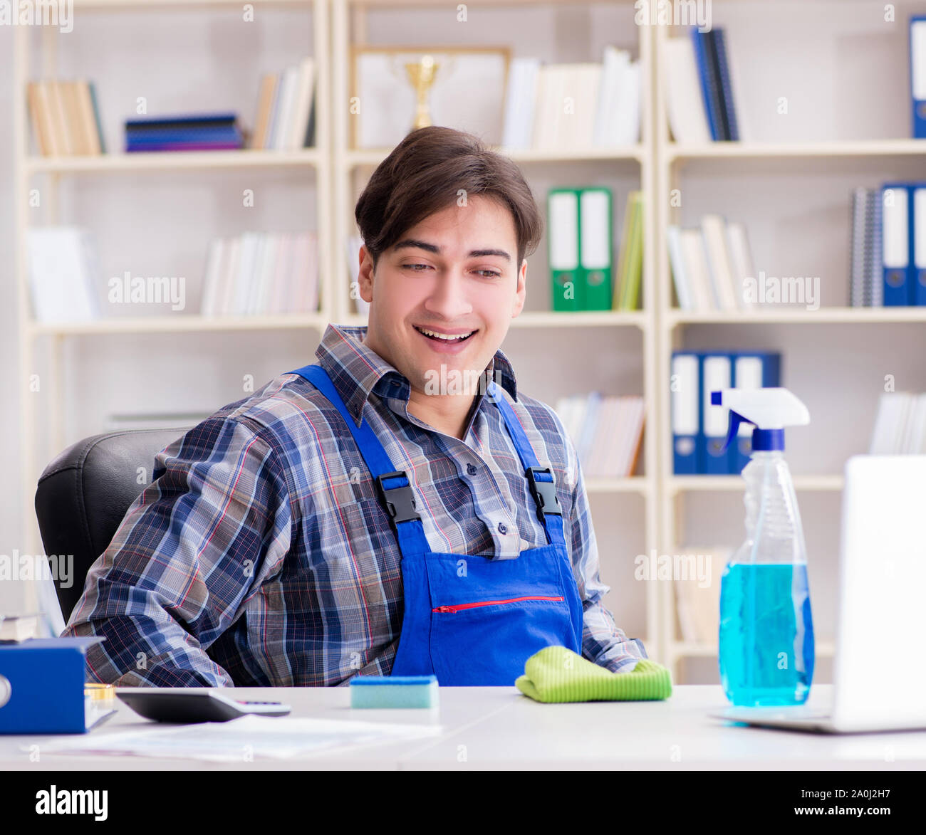 The male cleaner working in the office Stock Photo - Alamy