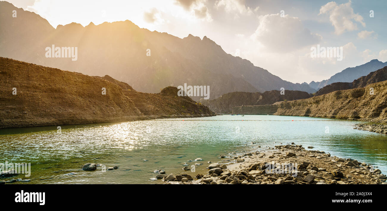 Scenic view of Hatta Lake and Hajar Mountains in the Emirate of Dubai ...