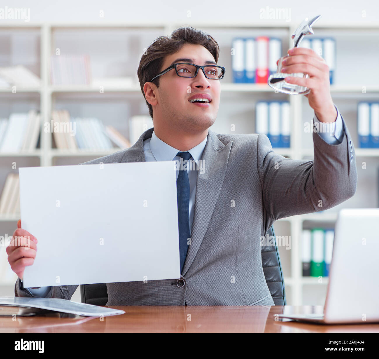 The businessman in office holding a blank message board Stock Photo - Alamy