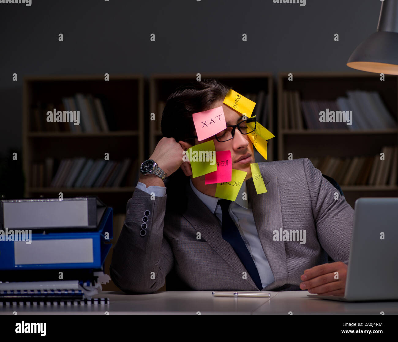 The businessman staying late to sort out priorities Stock Photo - Alamy