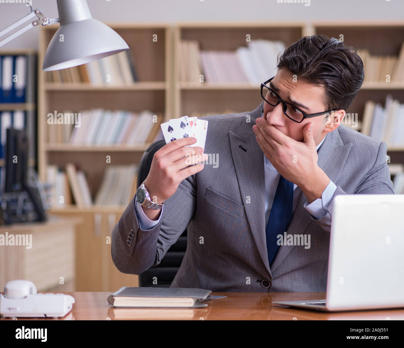 The businessman gambling playing cards at work Stock Photo - Alamy