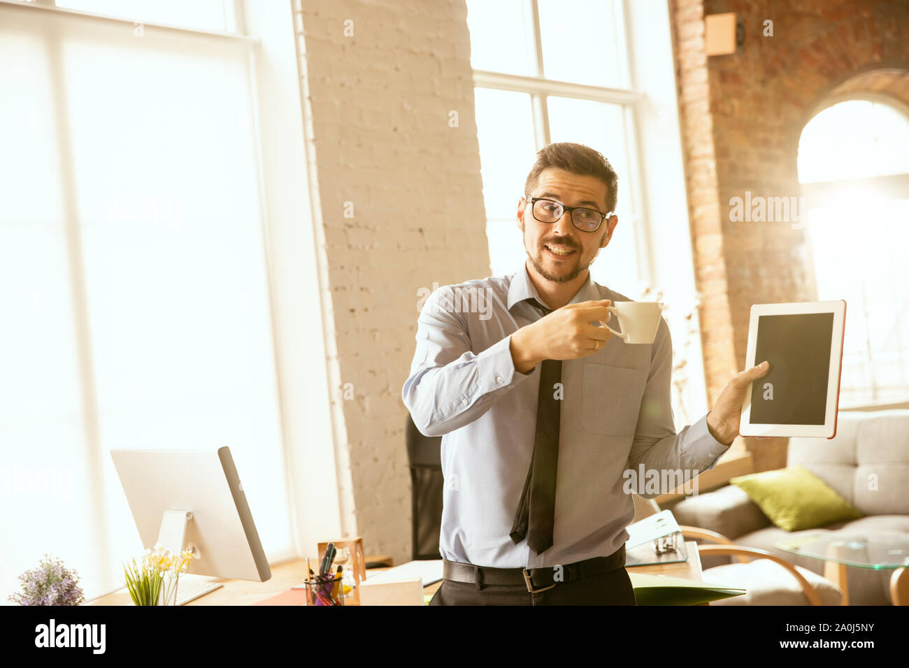 Deals. A young businessman working in the office, getting new work ...