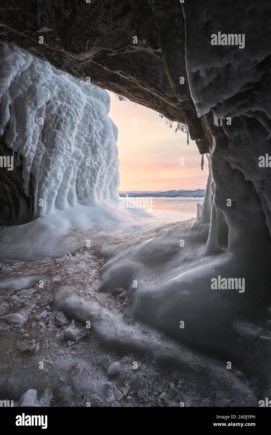 Ice cave at sunset in baikal lake Stock Photo - Alamy