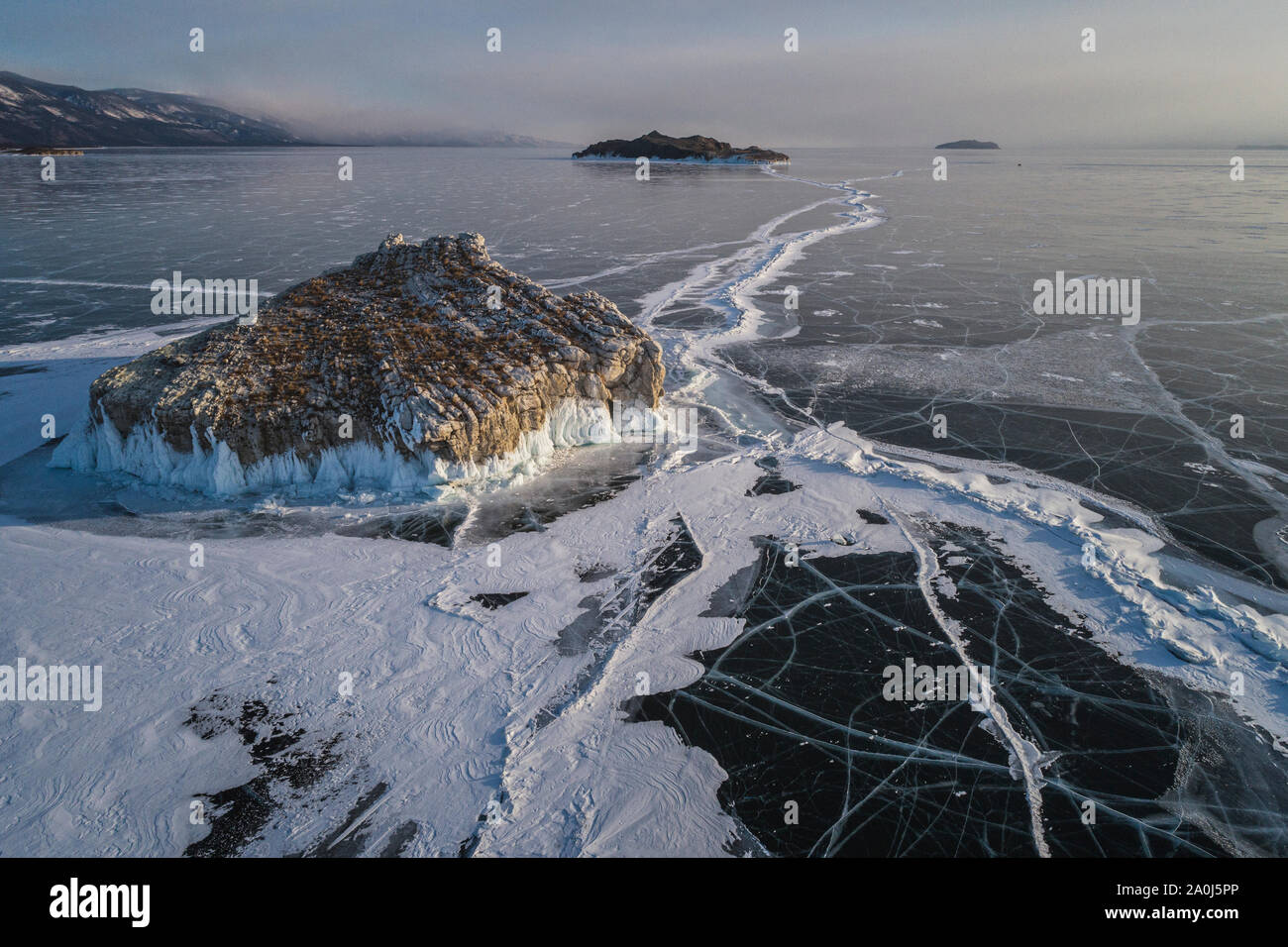 small islet surrounded by ice from aerial view Stock Photo - Alamy