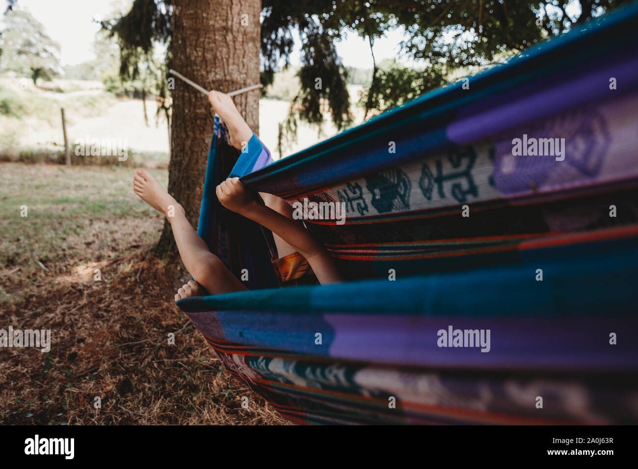 Faceless portrait of child in hammock with legs in the air Stock Photo ...