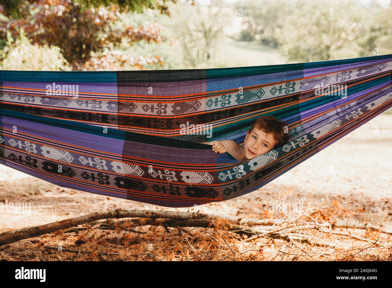 Side view of child relaxing in a hammock Stock Photo - Alamy