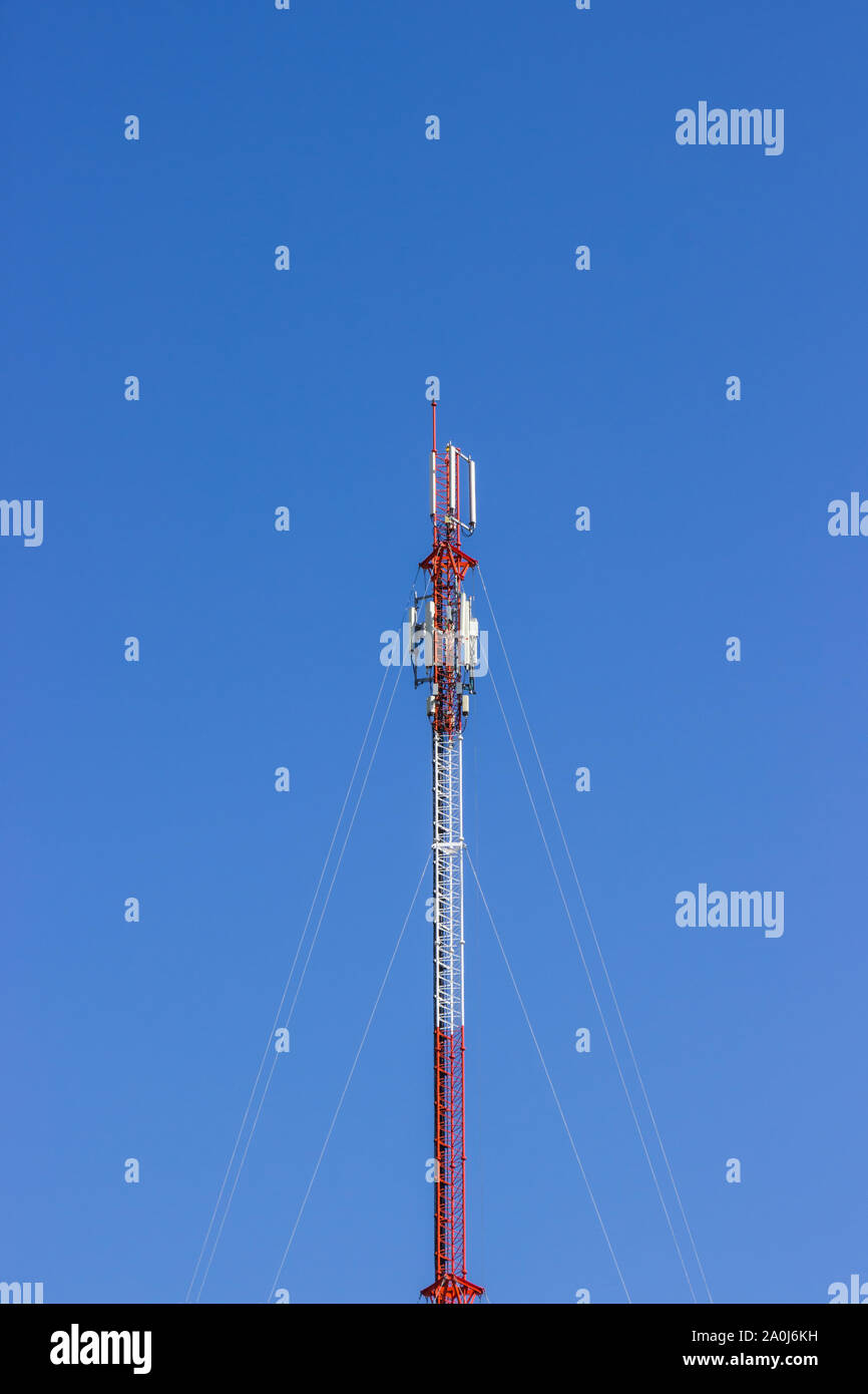 Red and white Telecommunication tower in a day of clear blue sky. Telephone pole Stock Photo - Alamy
