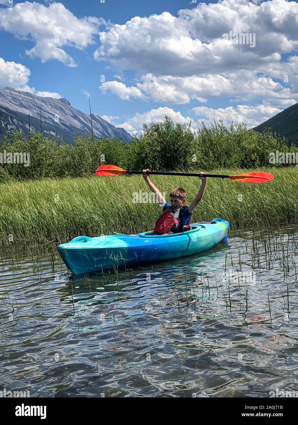 Boy kayaking on Vermilion Lakes in Banff National Park Stock Photo - Alamy