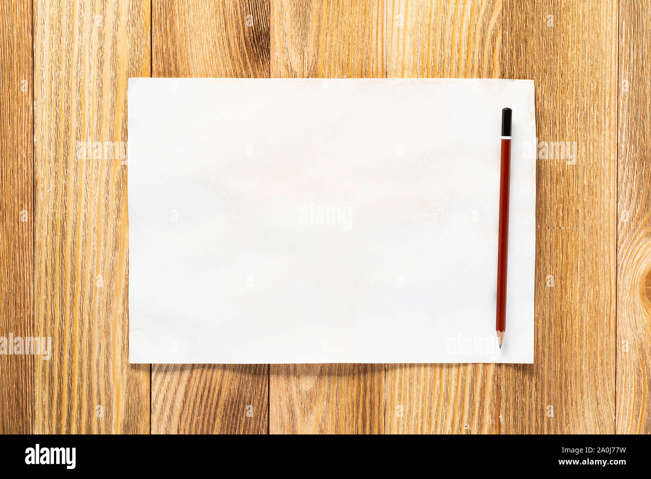 Artist workplace with sheet of paper and pencil lying on wooden desk ...