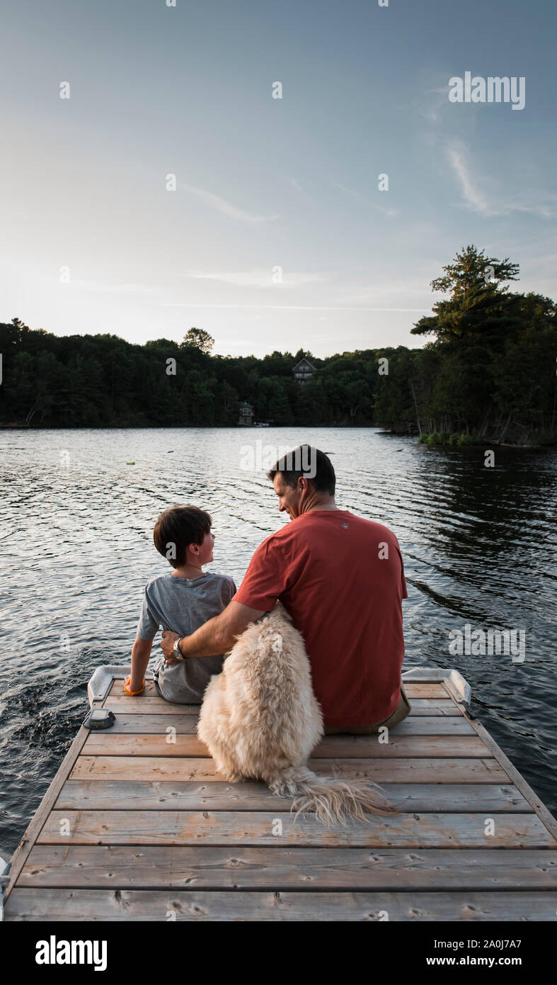 Man sitting on dock hi-res stock photography and images - Alamy