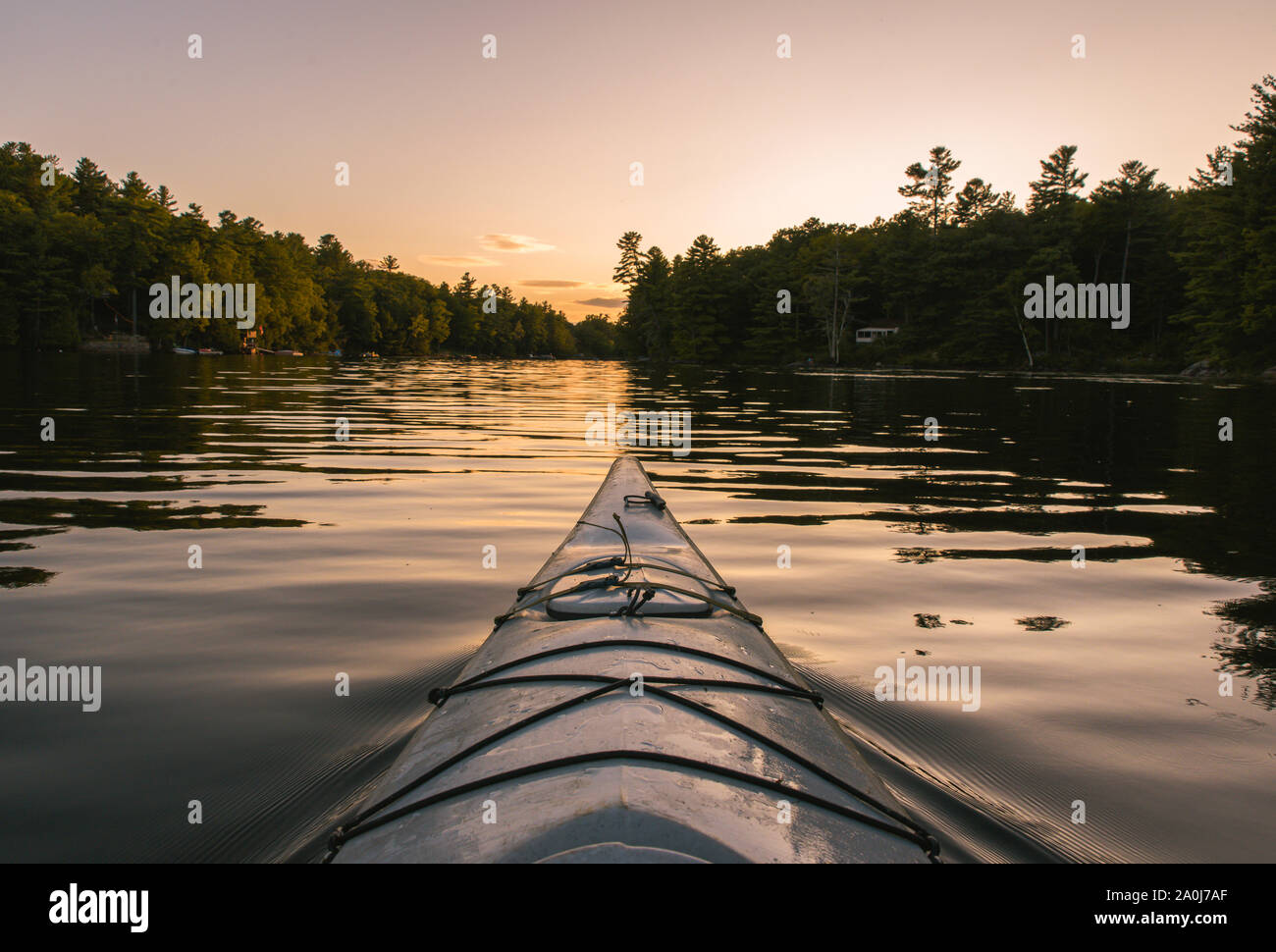 Kayaking on calm water at sunset from point of view of paddler Stock ...