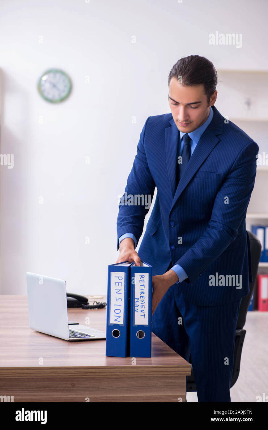 The young male accountant working in the office Stock Photo - Alamy