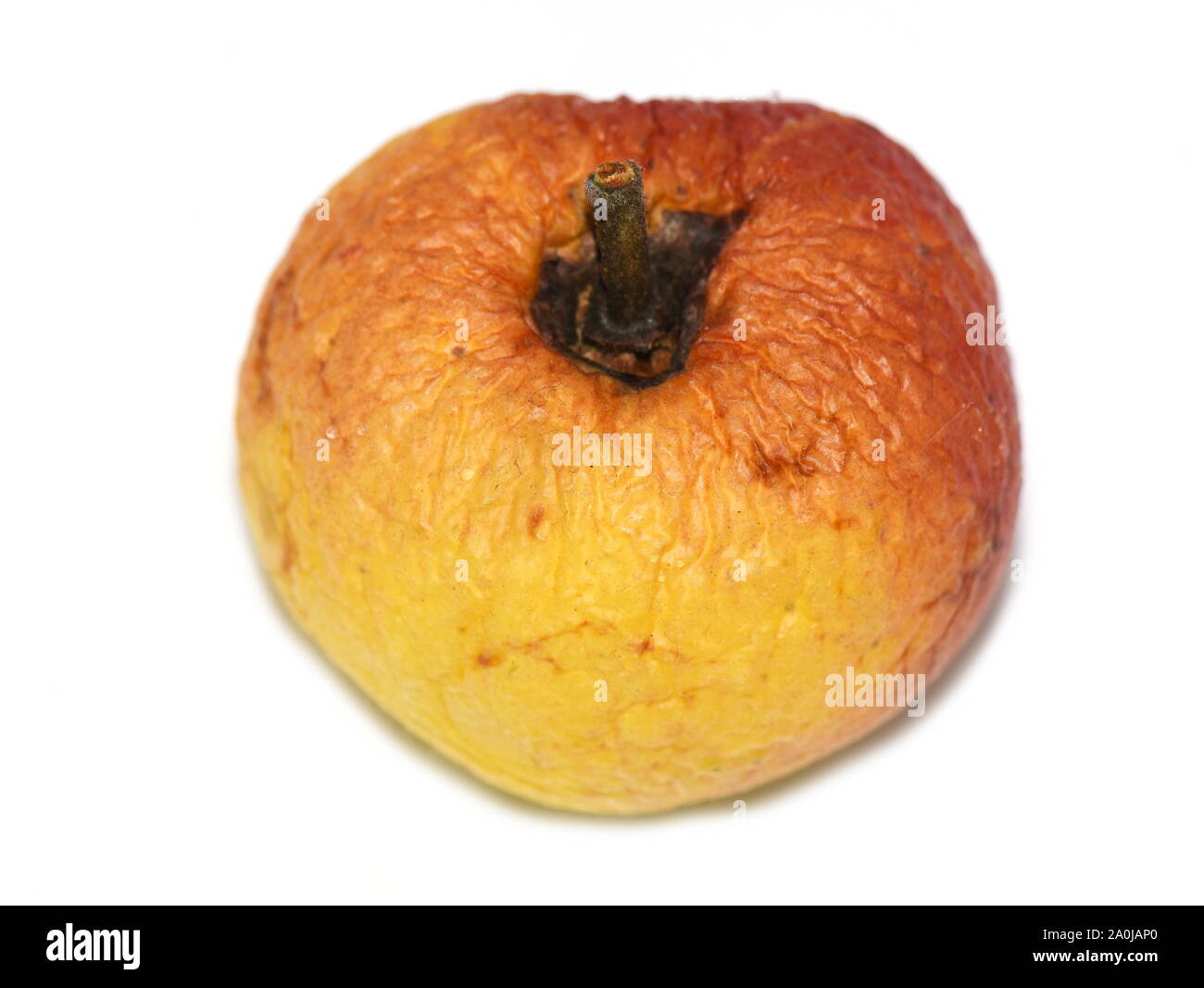 Wrinkled old apple isolated on white background Stock Photo - Alamy